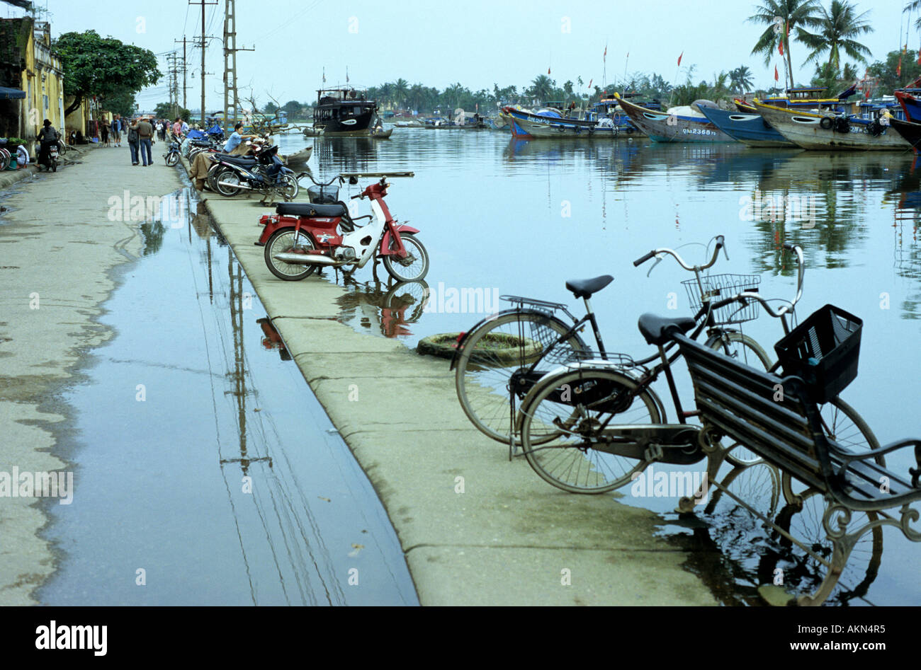 High waters of the Thu Bon river flood the paving and road along Bach ...