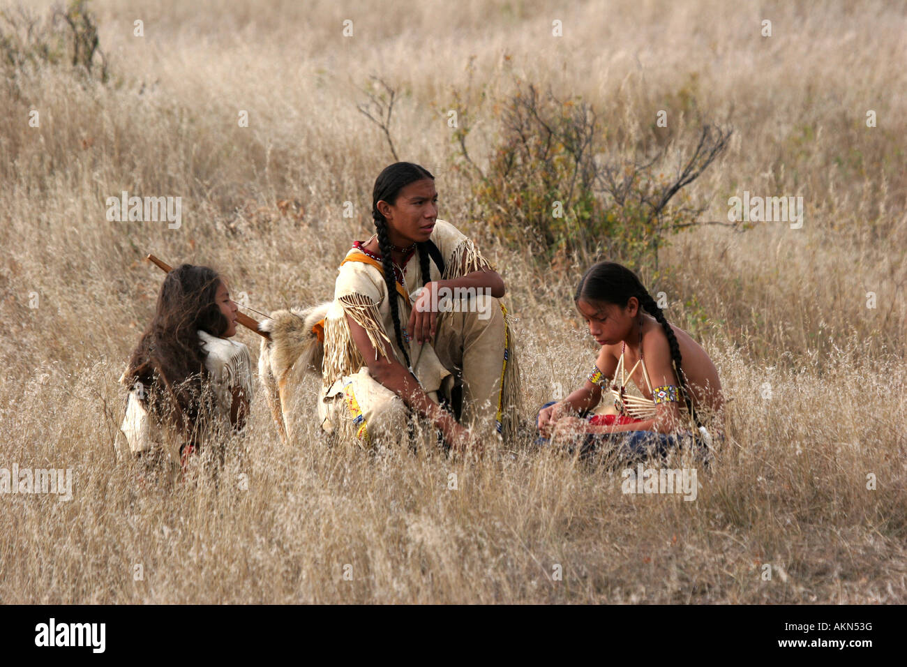 Three Native American Indian Children using the ground to show a map of ...