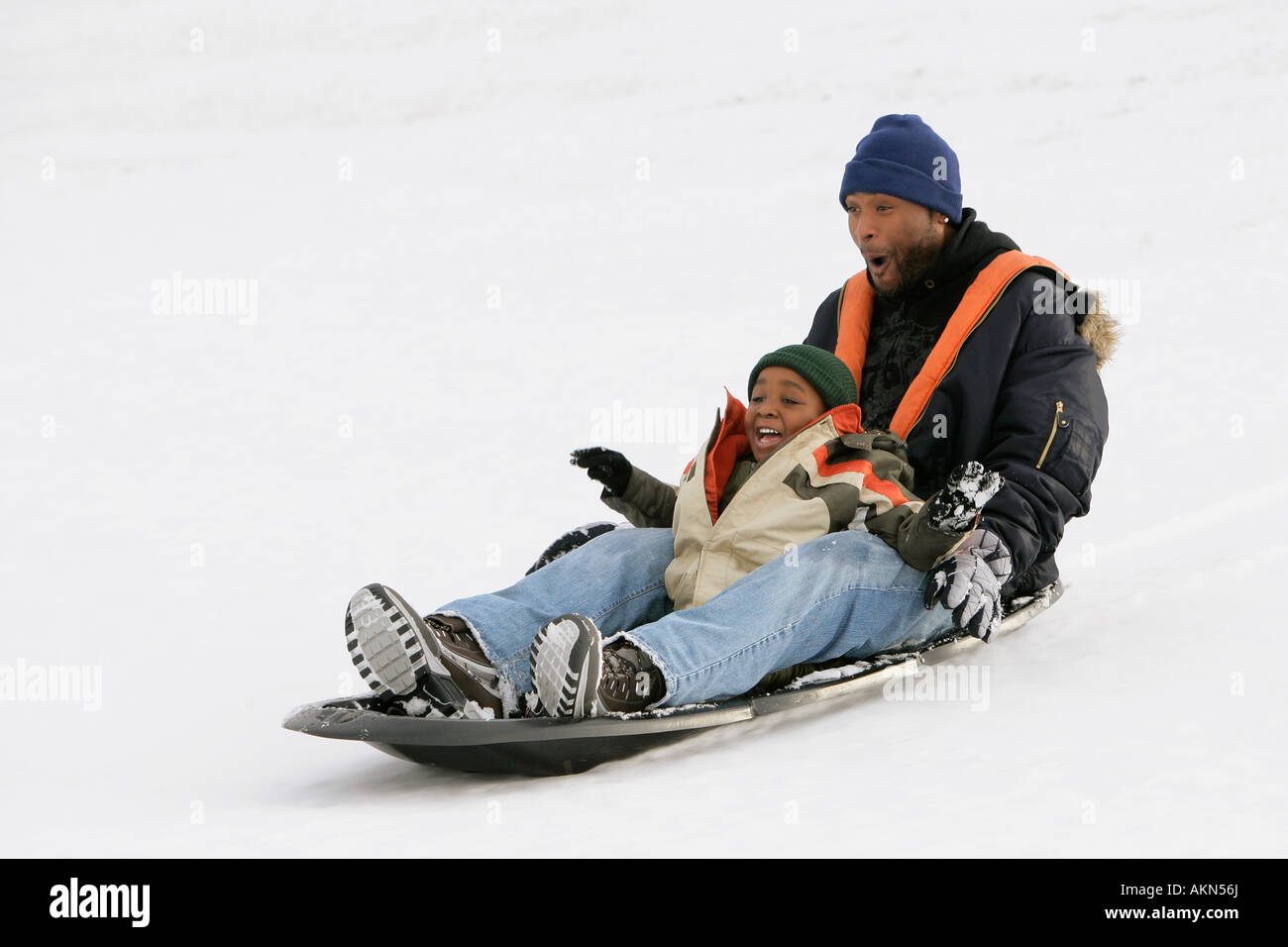 Father and son sledding on snow Stock Photo - Alamy