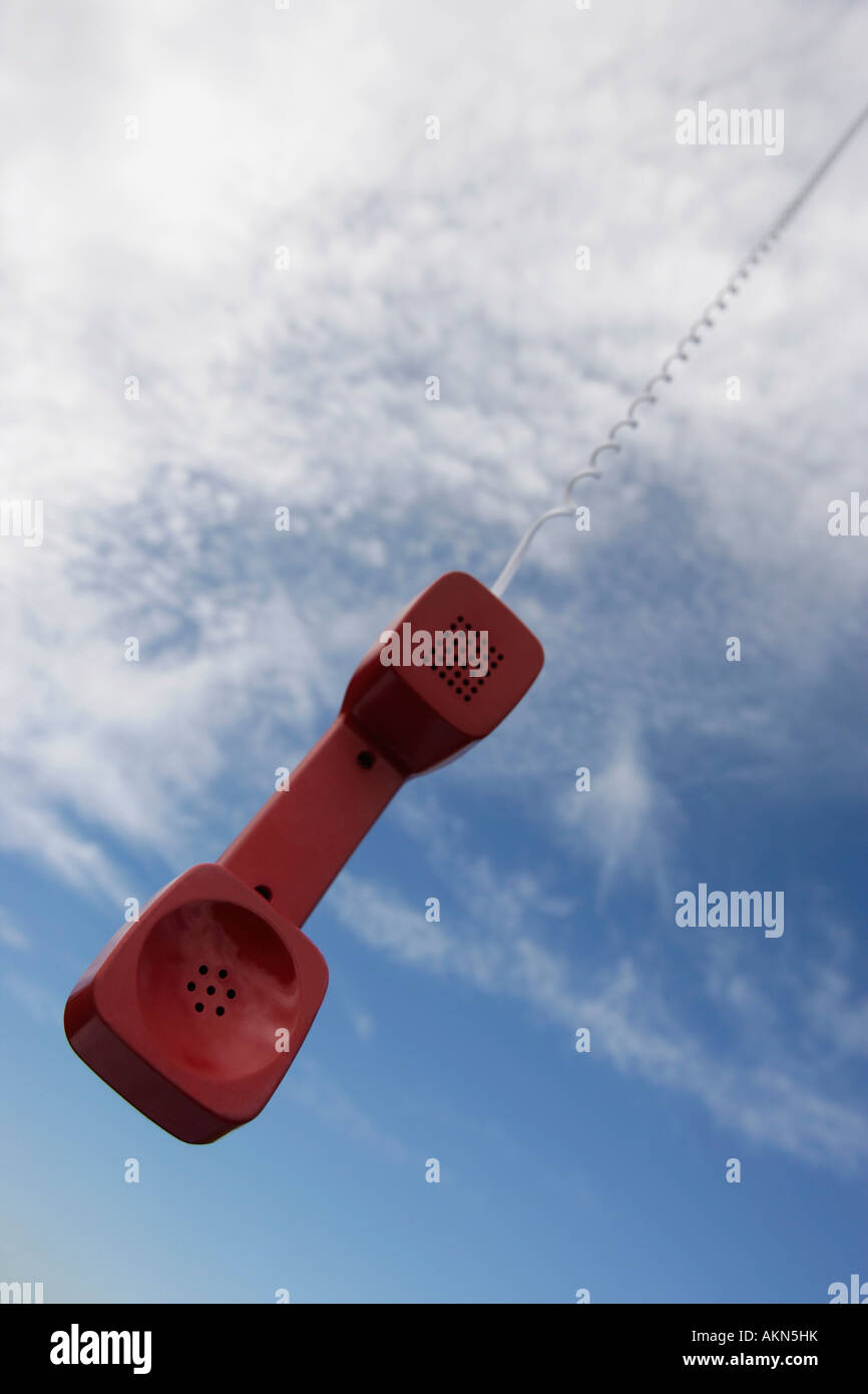 A telephone receiver dangling from the sky Stock Photo - Alamy