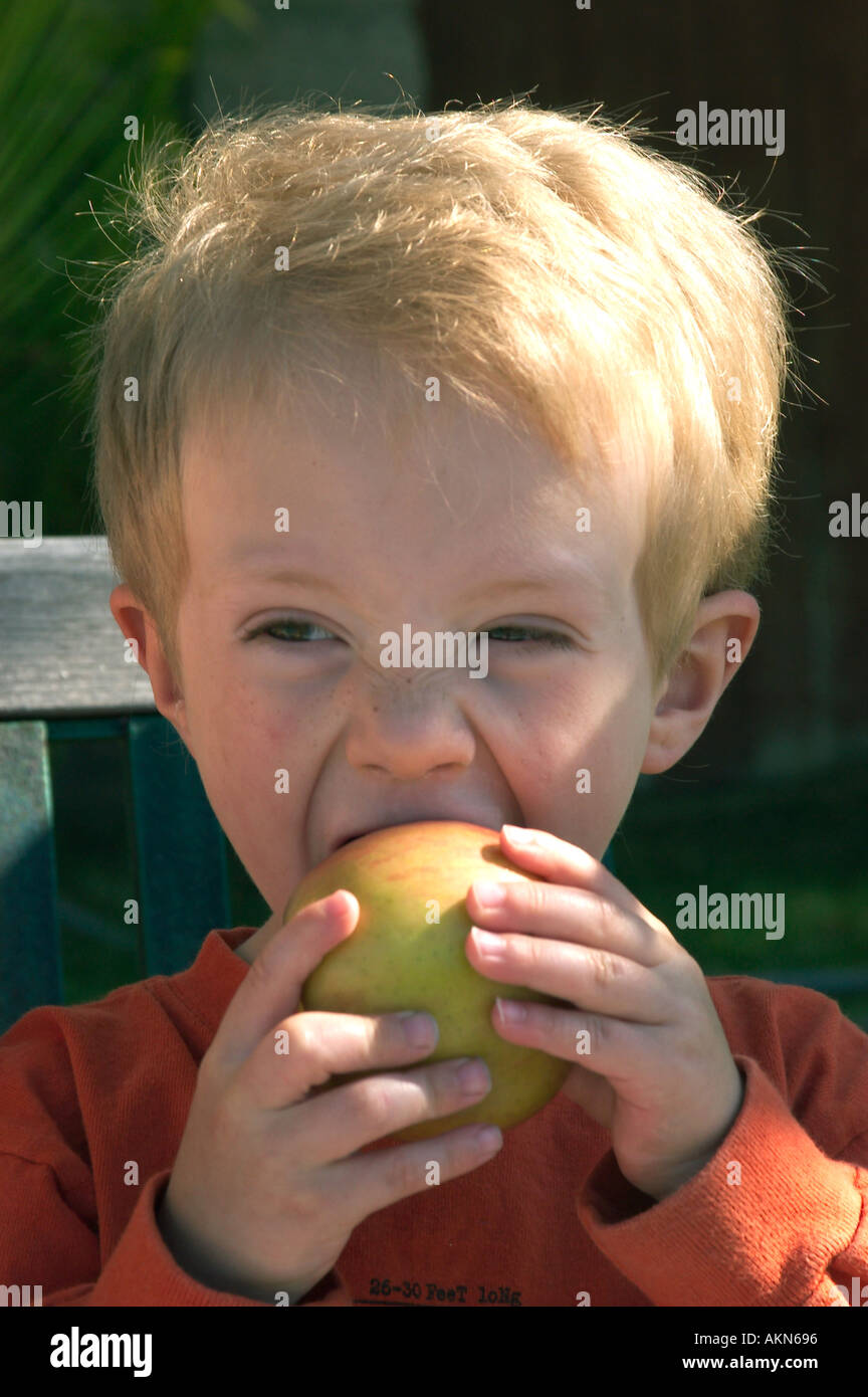 boy eating apple Stock Photo - Alamy