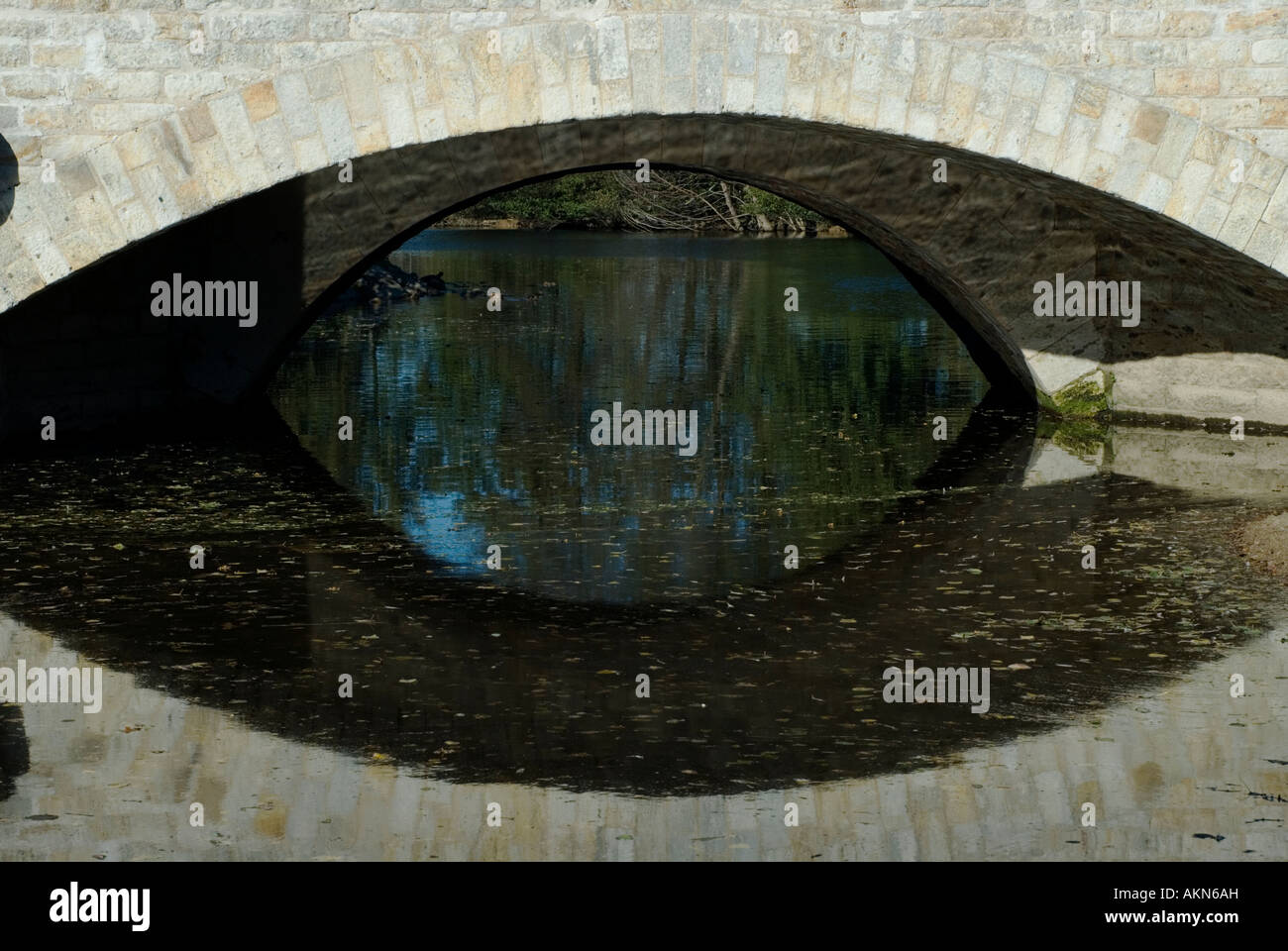 Stock Photo of a the reflections under an Arched bridge Stock Photo - Alamy