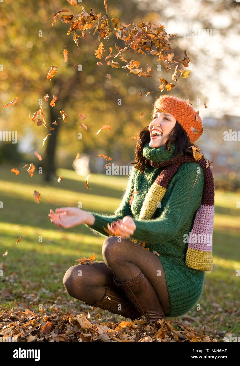 Brunette girl collecting Autumn leaves Stock Photo - Alamy