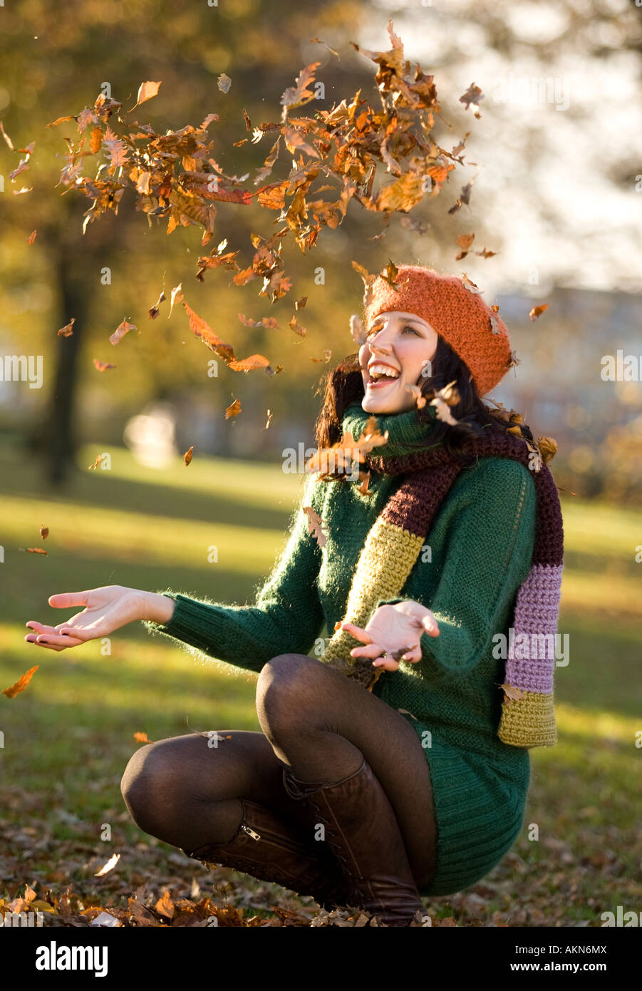 Brunette girl collecting Autumn leaves Stock Photo - Alamy