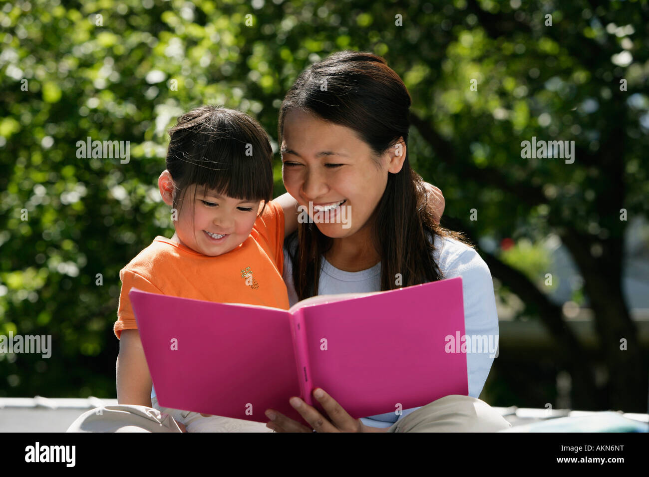 Mother and child reading Stock Photo - Alamy