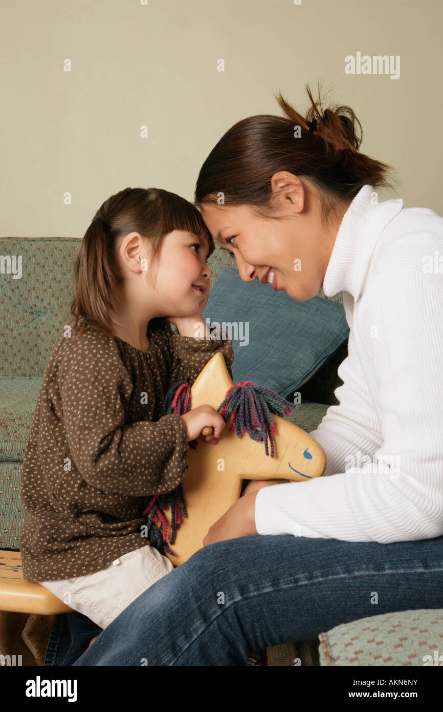 Mother sitting with daughter Stock Photo - Alamy