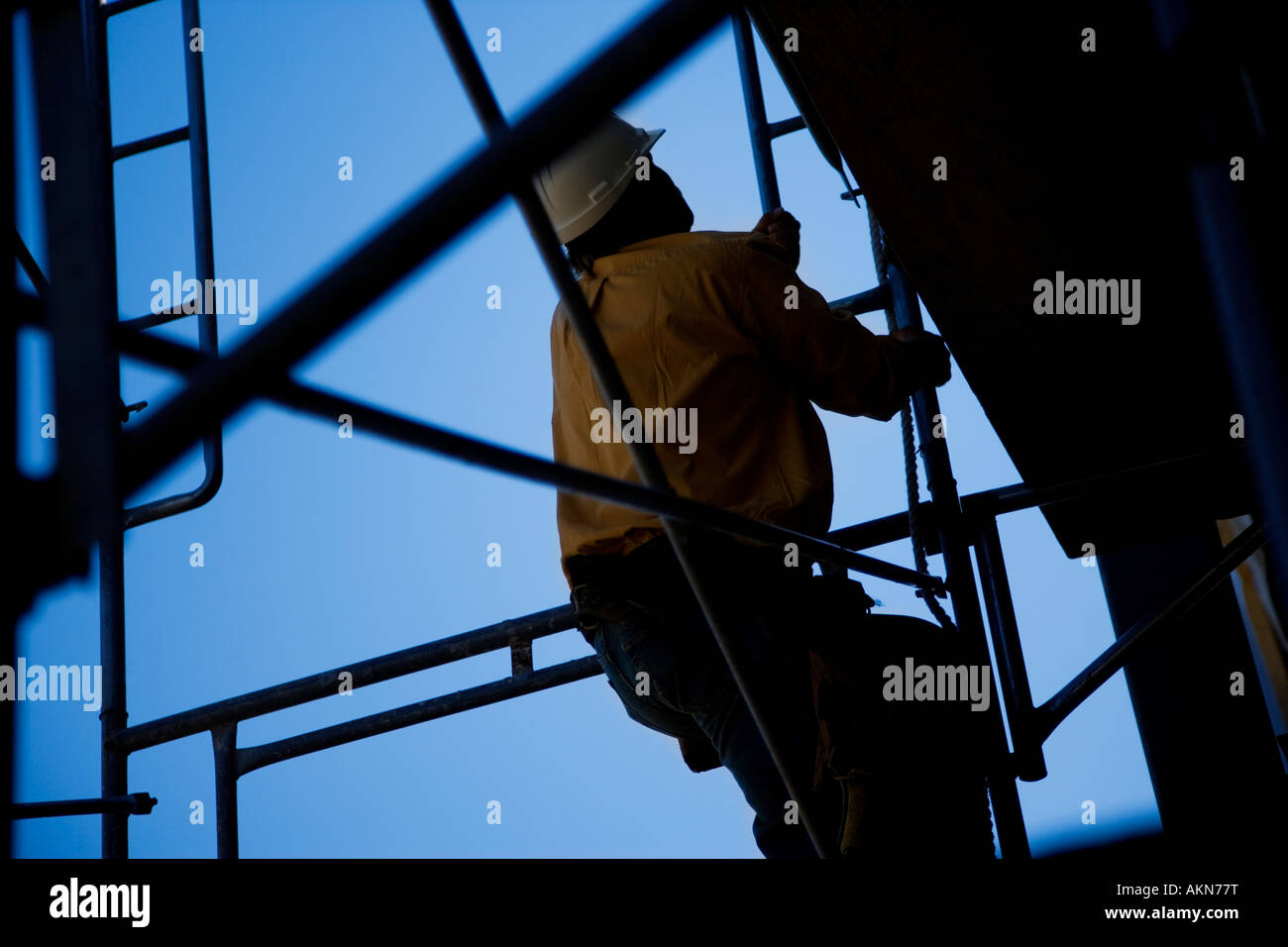 Construction worker climbing Stock Photo - Alamy
