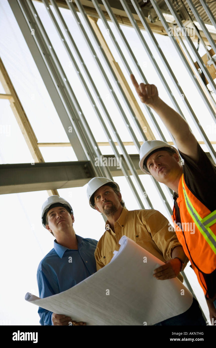 Men discussing architecture of a structure Stock Photo - Alamy