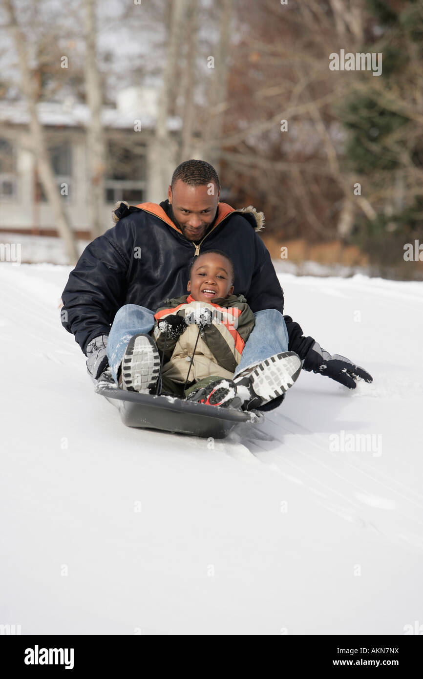 Father and son sledding on snow Stock Photo - Alamy