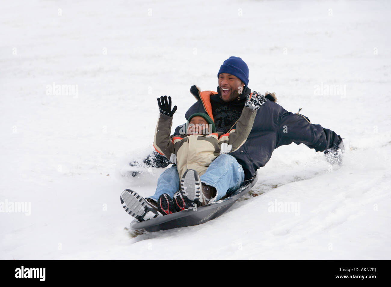 Father and son sledding on snow Stock Photo - Alamy