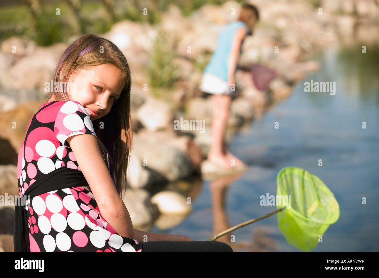 Two girls on the shore Stock Photo - Alamy