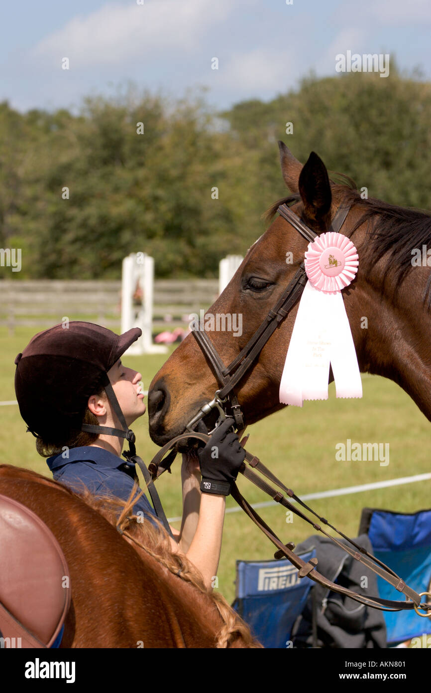 Equestrian competitor showing affection for her award winning horse ...