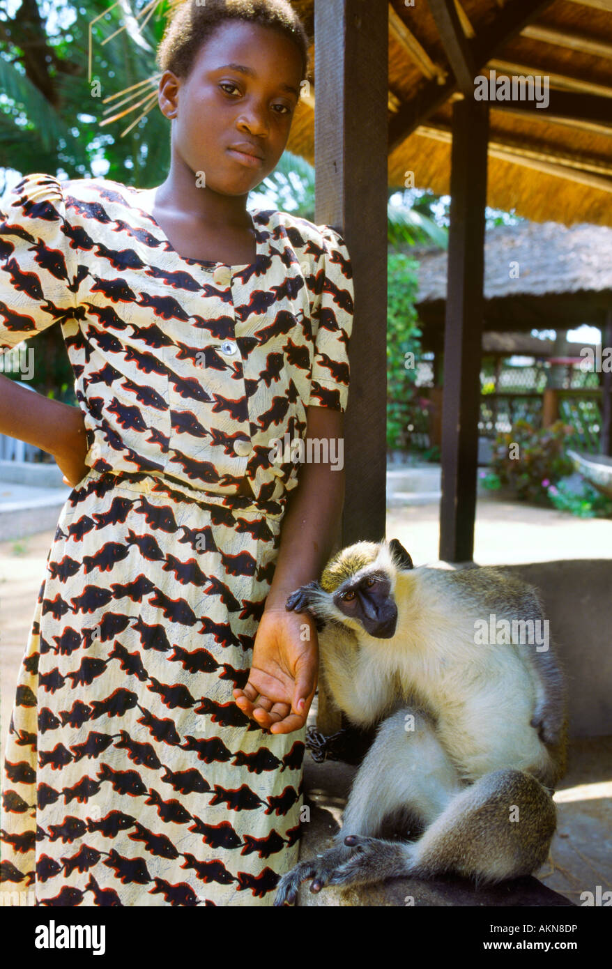 A young woman poses with a pet monkey in Grand Bassam Cote d'Ivoire ...