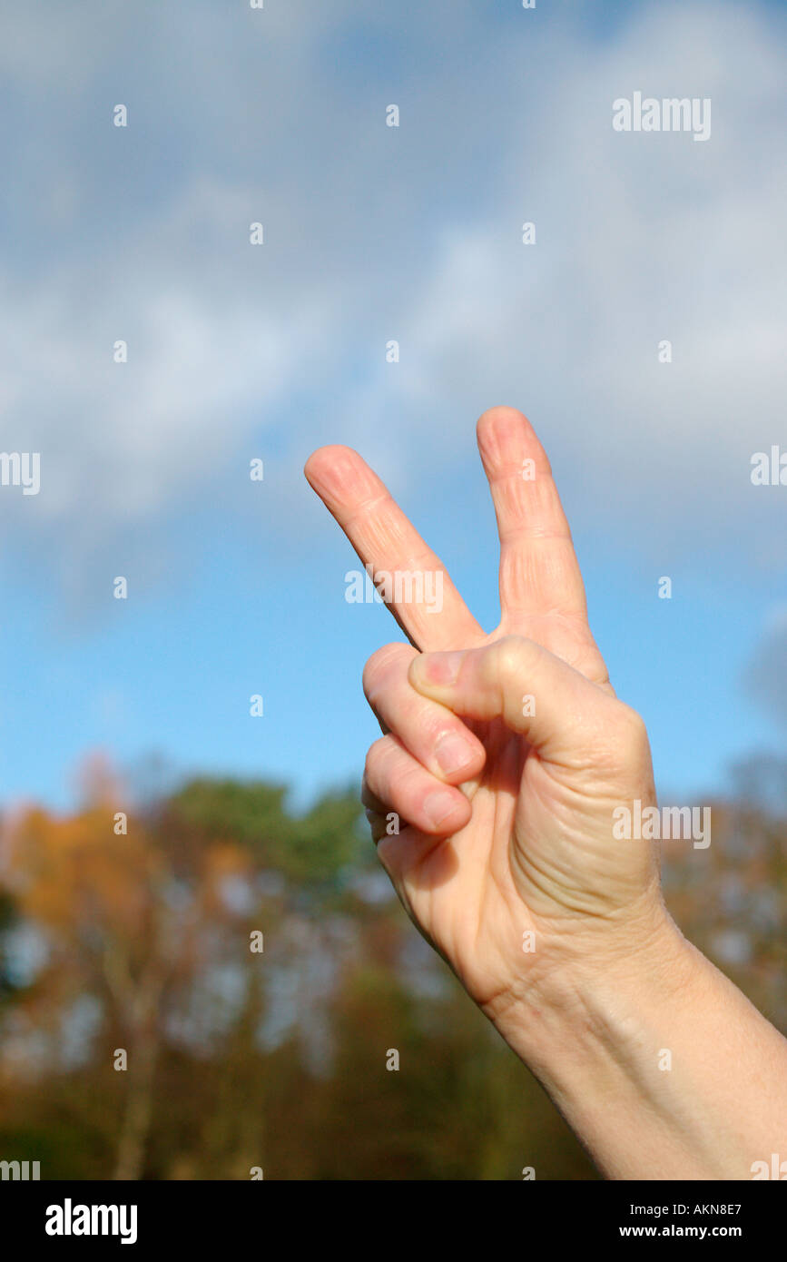 Hand victory sign Stock Photo - Alamy