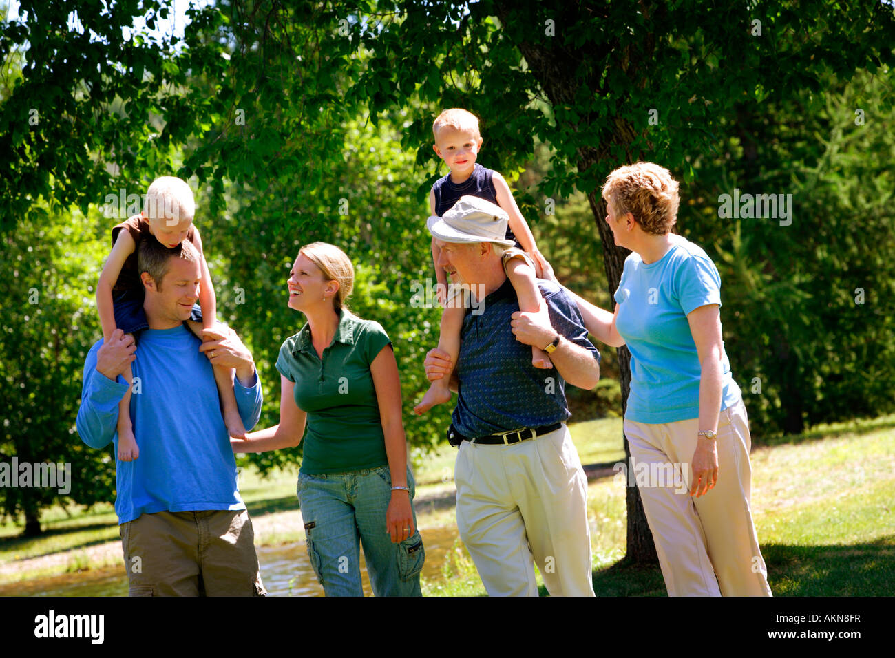 A family going for a walk in a park Stock Photo - Alamy