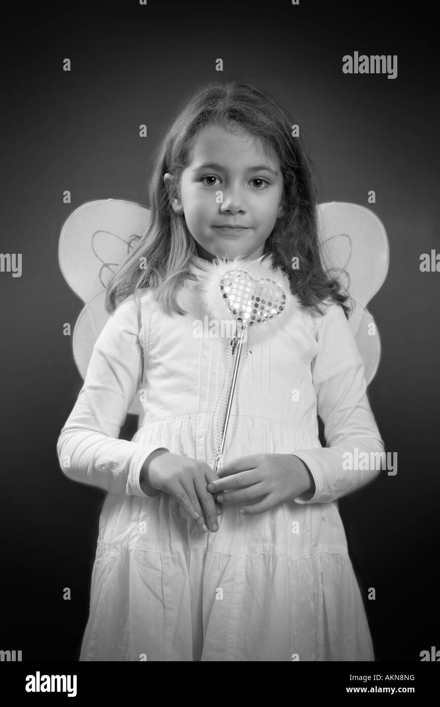 Young white angel holding a magic stick Stock Photo - Alamy