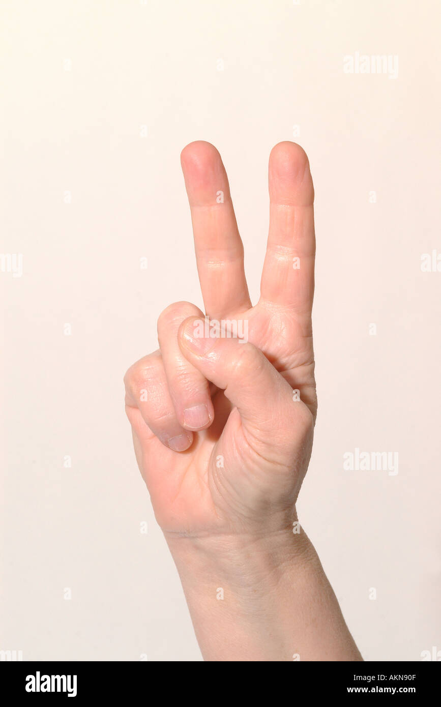 Hand victory sign Stock Photo - Alamy