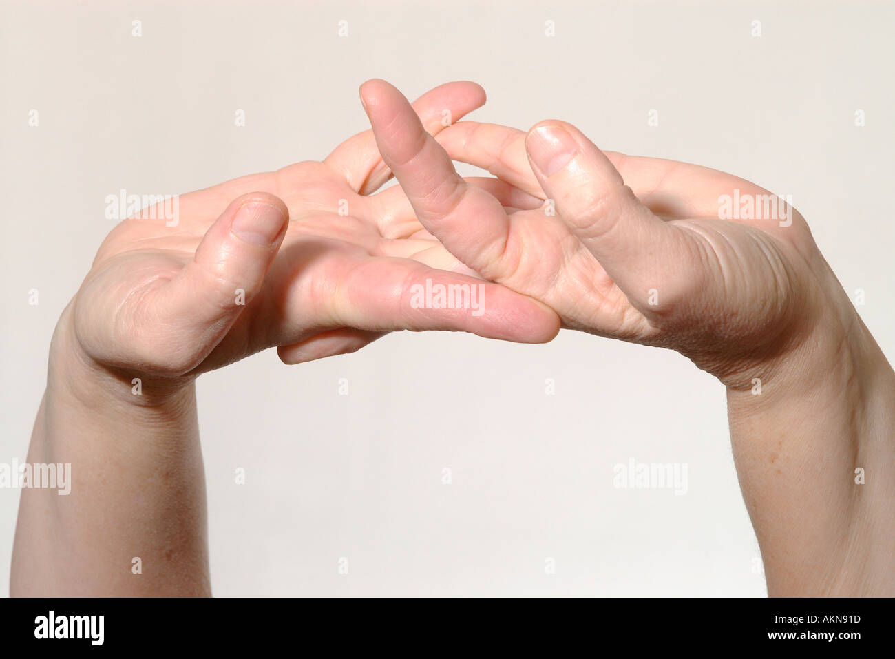Hands twisted backwards Stock Photo - Alamy