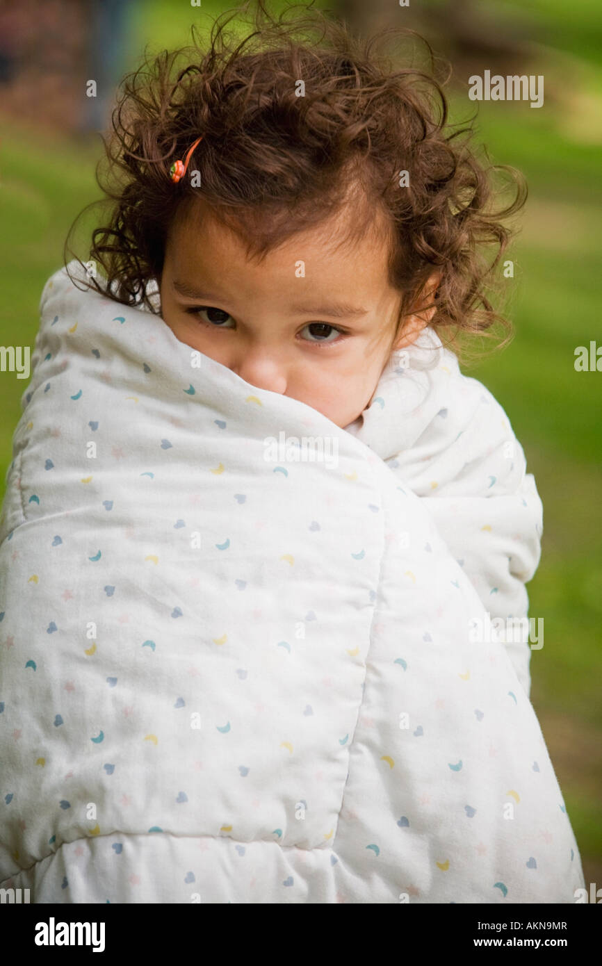 Girl with a blanket wrapped around her Stock Photo - Alamy