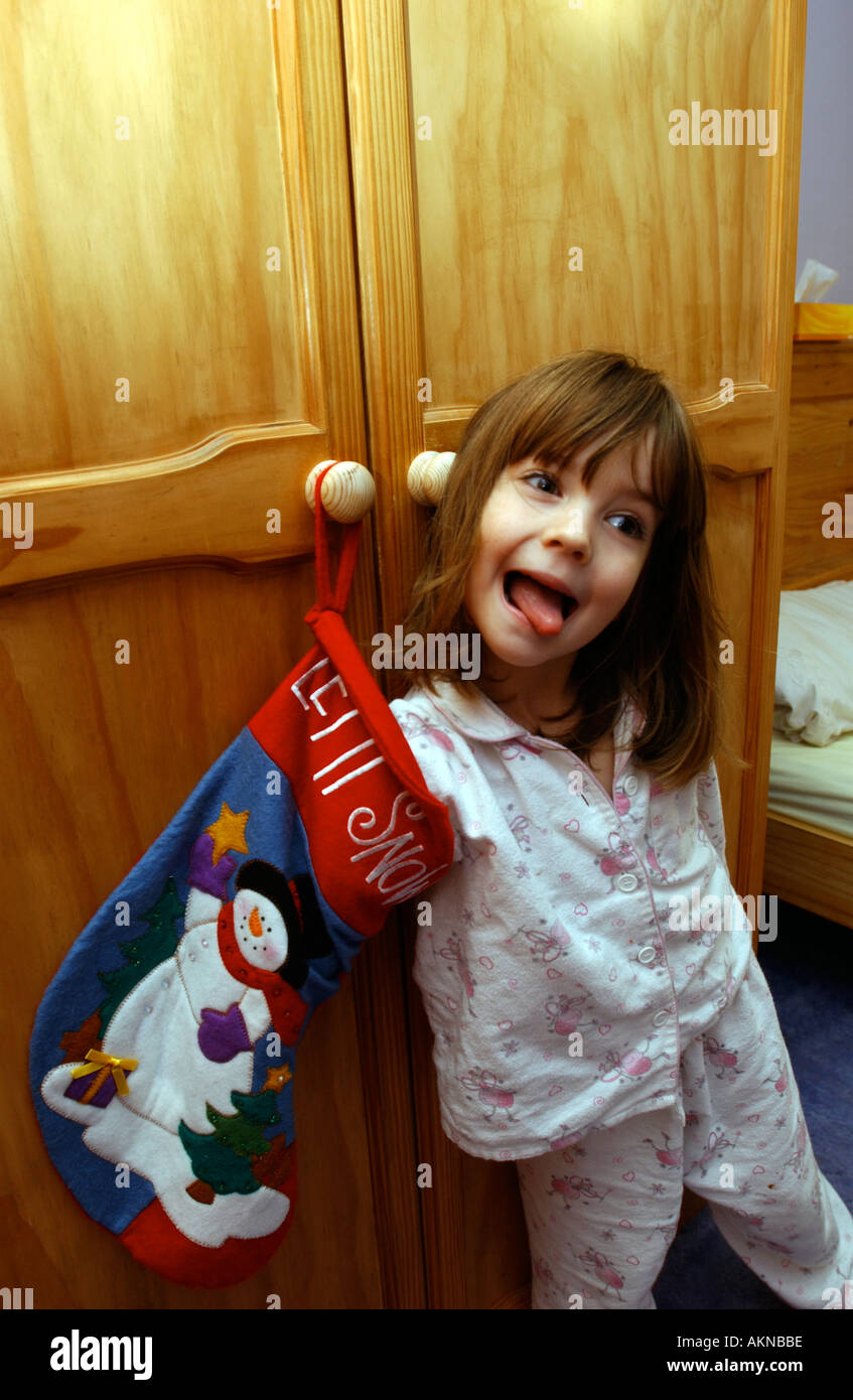 Christmas stocking. A little girl opens her stocking full of presents ...