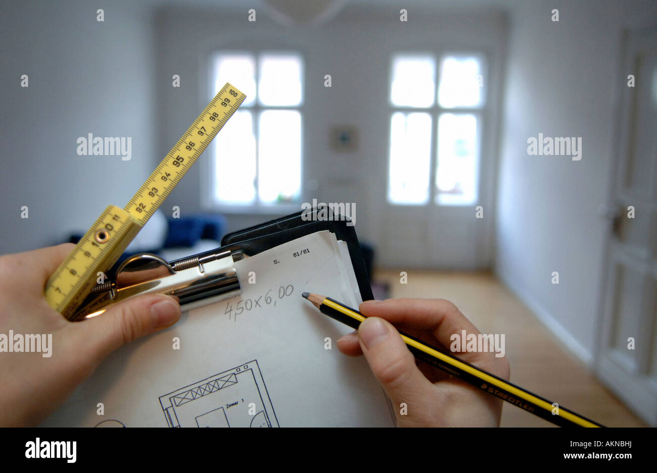 Architect measuring an apartment Stock Photo - Alamy