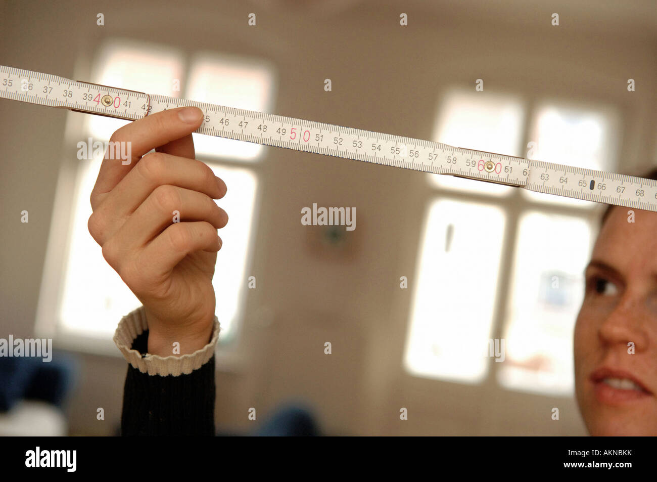 Architect measuring an apartment Stock Photo - Alamy