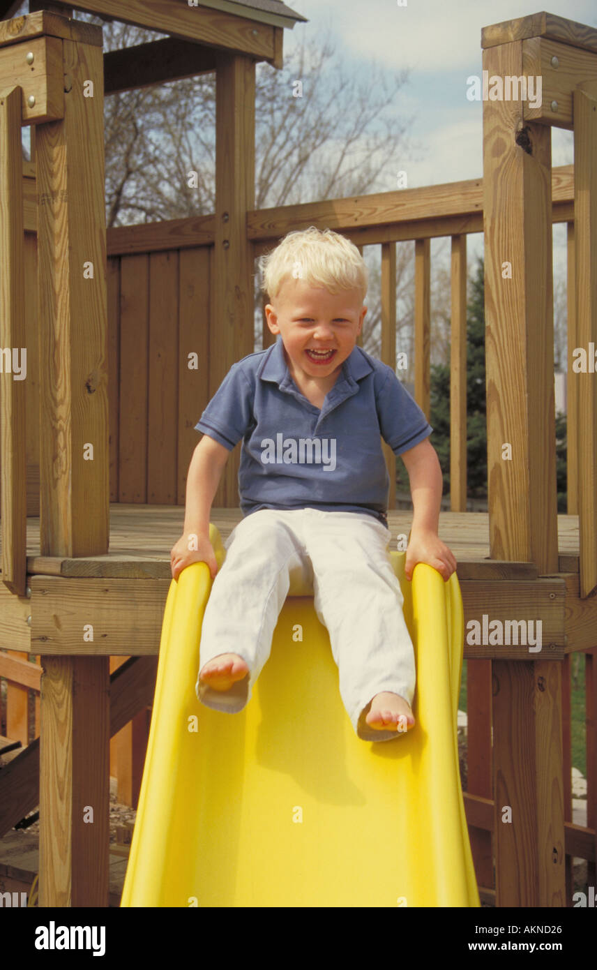 Grade school boy on slide Stock Photo - Alamy