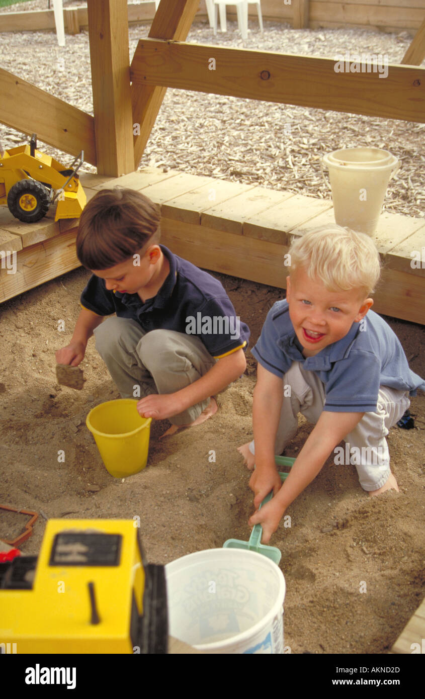 Grade school boys playing in a sandbox Stock Photo - Alamy