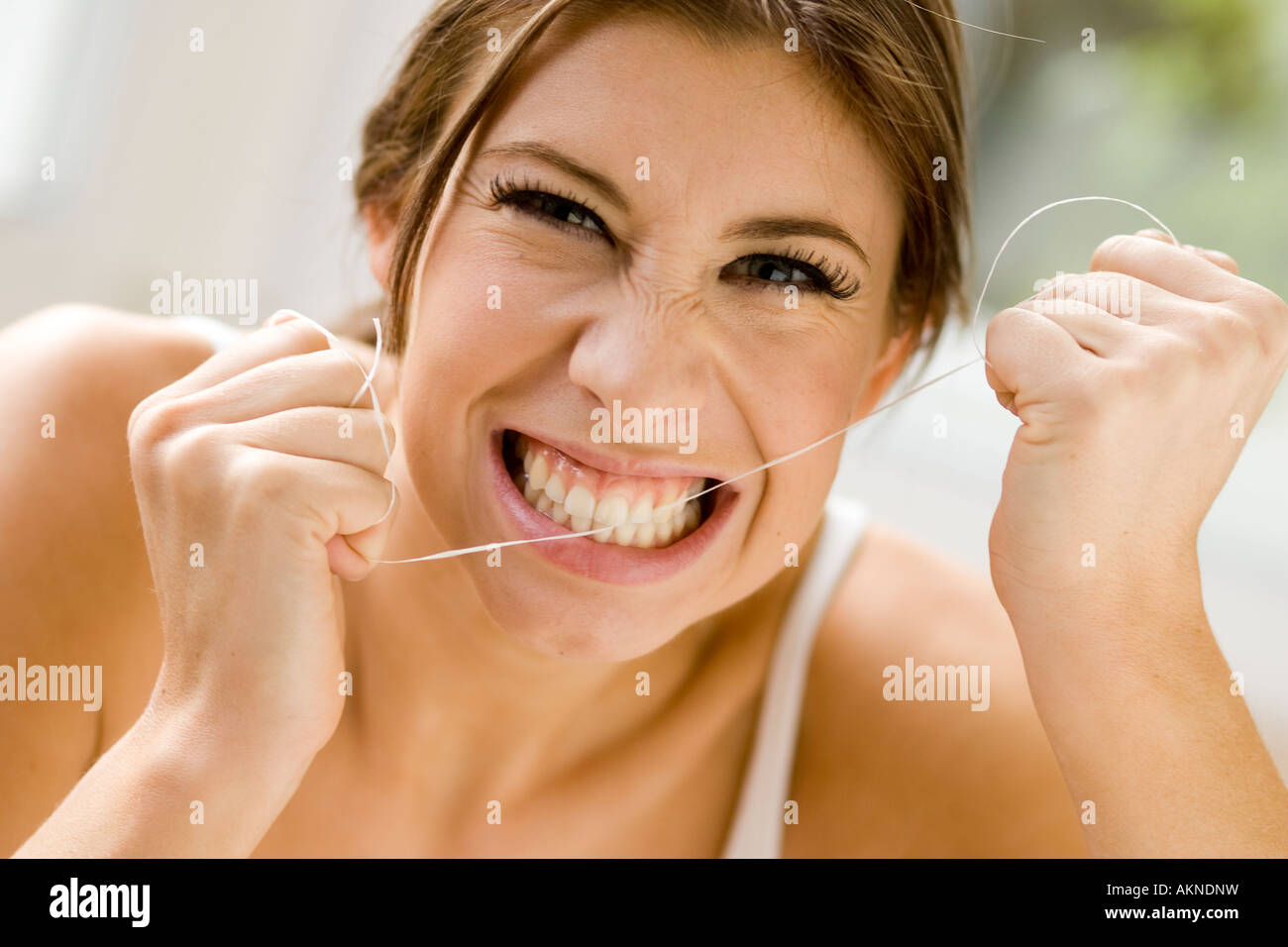 Girl flossing teeth Stock Photo - Alamy