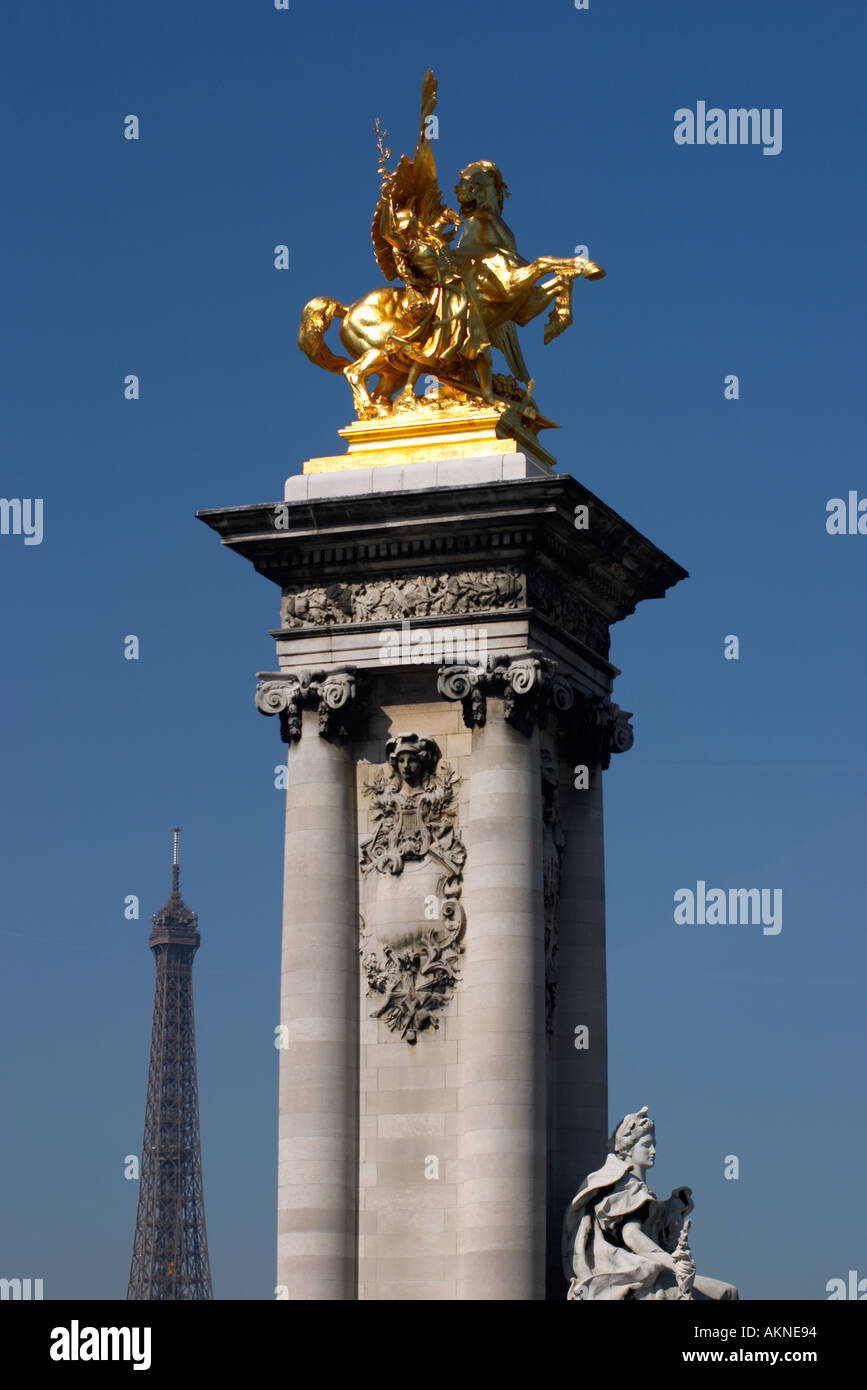 One of four gilded statues on pillars at each corner of the Pont ...