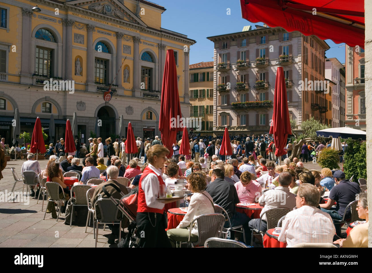 People sitting in a pavement cafea t Piazza della Riforma Lugano Lake ...