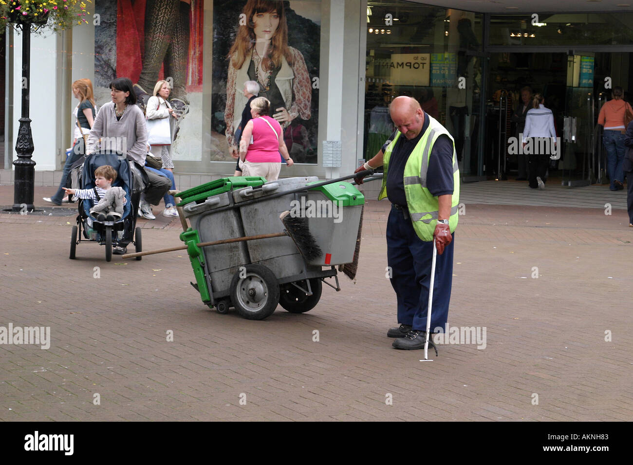 man cleaning the street in a town centre in the uk Stock Photo - Alamy