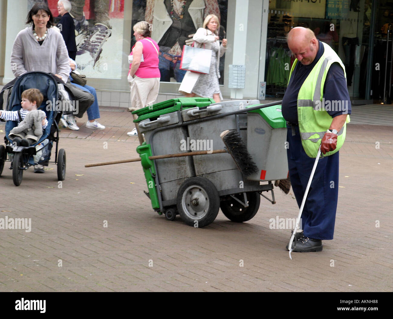man cleaning the street in a town centre in the uk Stock Photo - Alamy