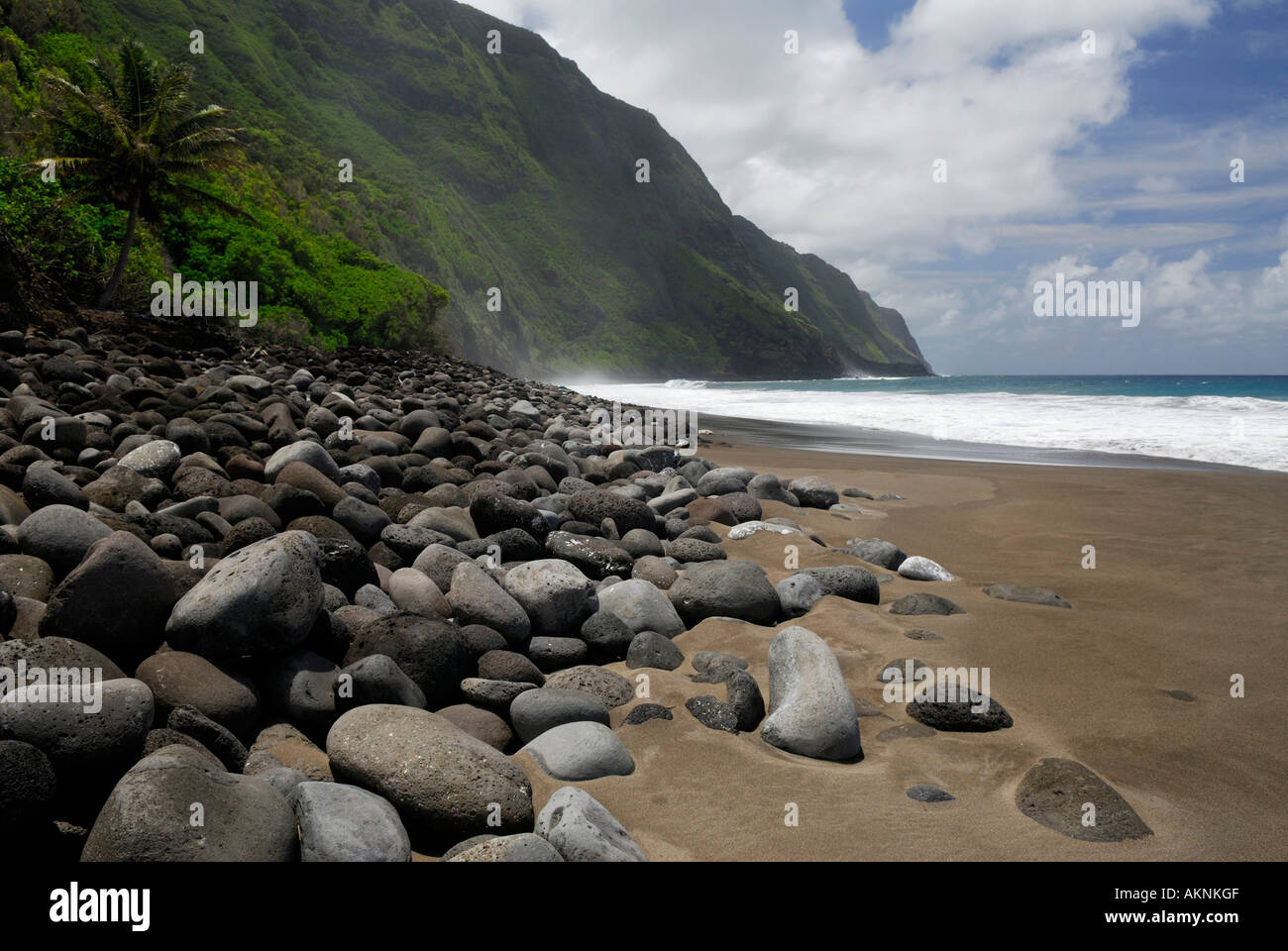 Black sand beach and steep Pali sea cliffs at Kalaupapa leper colony ...