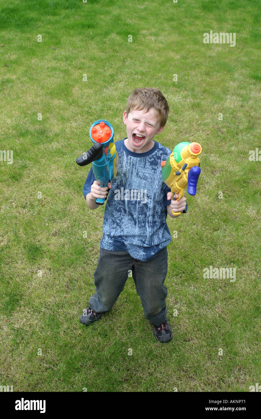 Boy shooting water pistol hi-res stock photography and images - Alamy