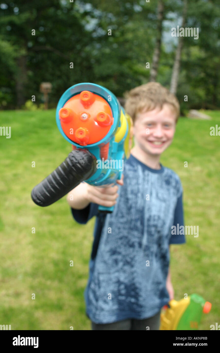 Boy shooting water pistol hi-res stock photography and images - Alamy
