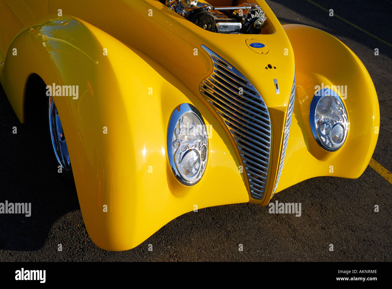Front end of a Classic restored yellow Ford hotrod modified with souped ...