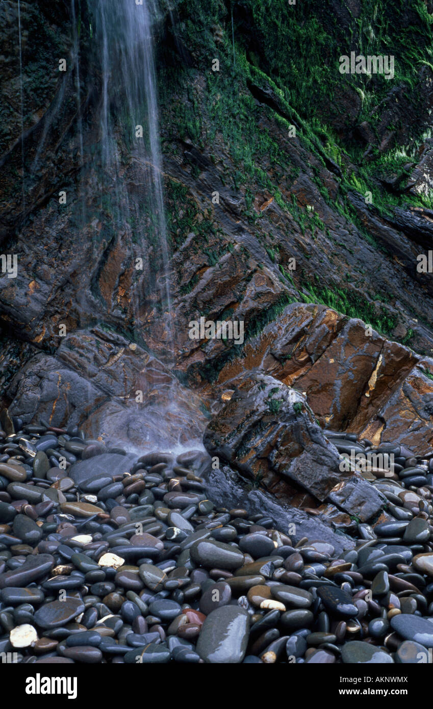 Small waterfall on the beach at Sandymouth, Cornwall, UK Stock Photo ...
