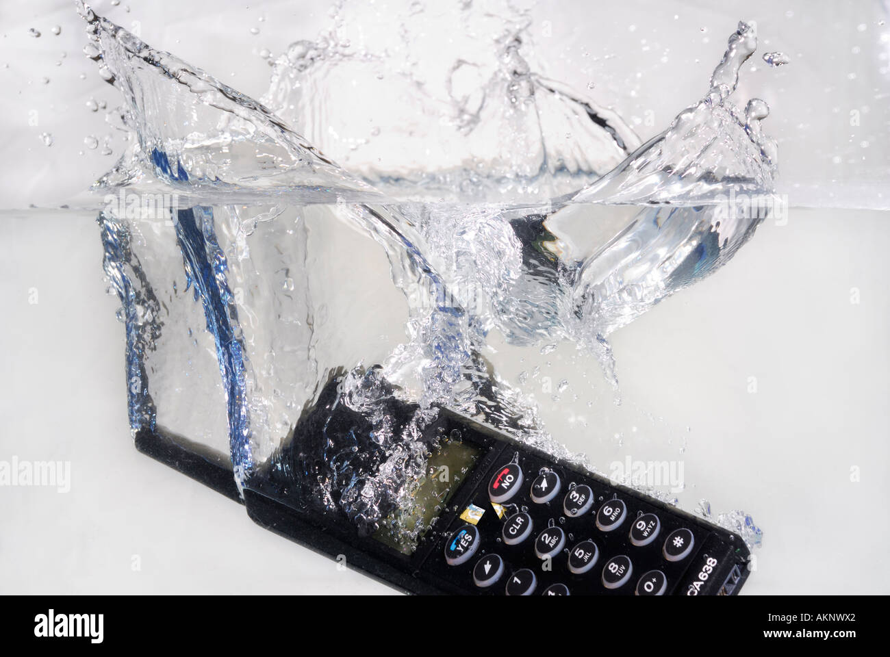 Cell phone splashing after being dropped into water Stock Photo - Alamy