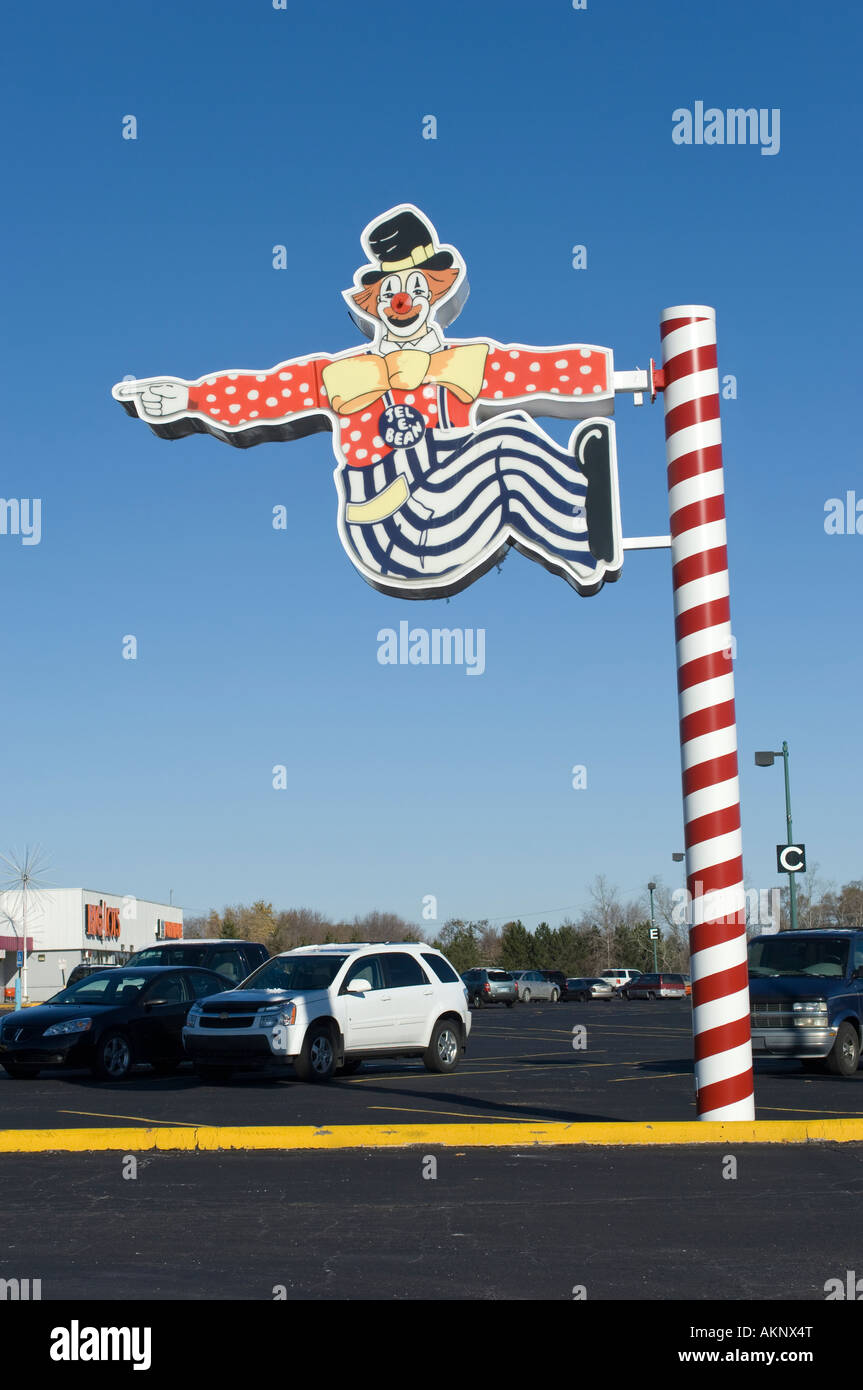 Pointing clown figure on a striped pole in a mall parking lot Stock ...