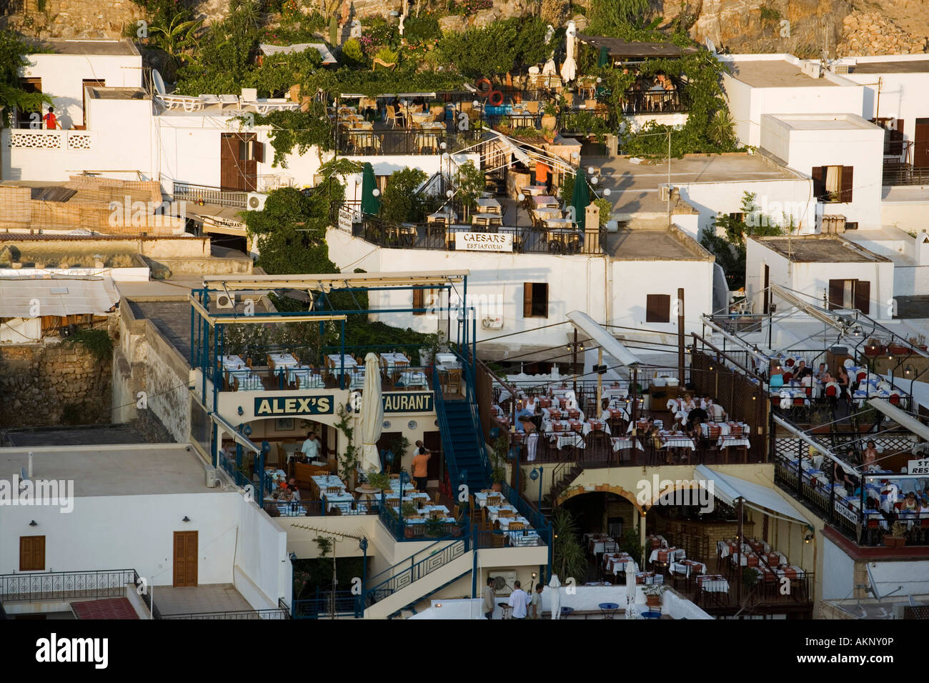 View over town in the evening people sitting on terraces of restaurants ...