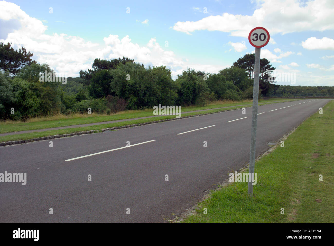 thirty mile per hour speed limit signpost at of empty road Stock Photo ...