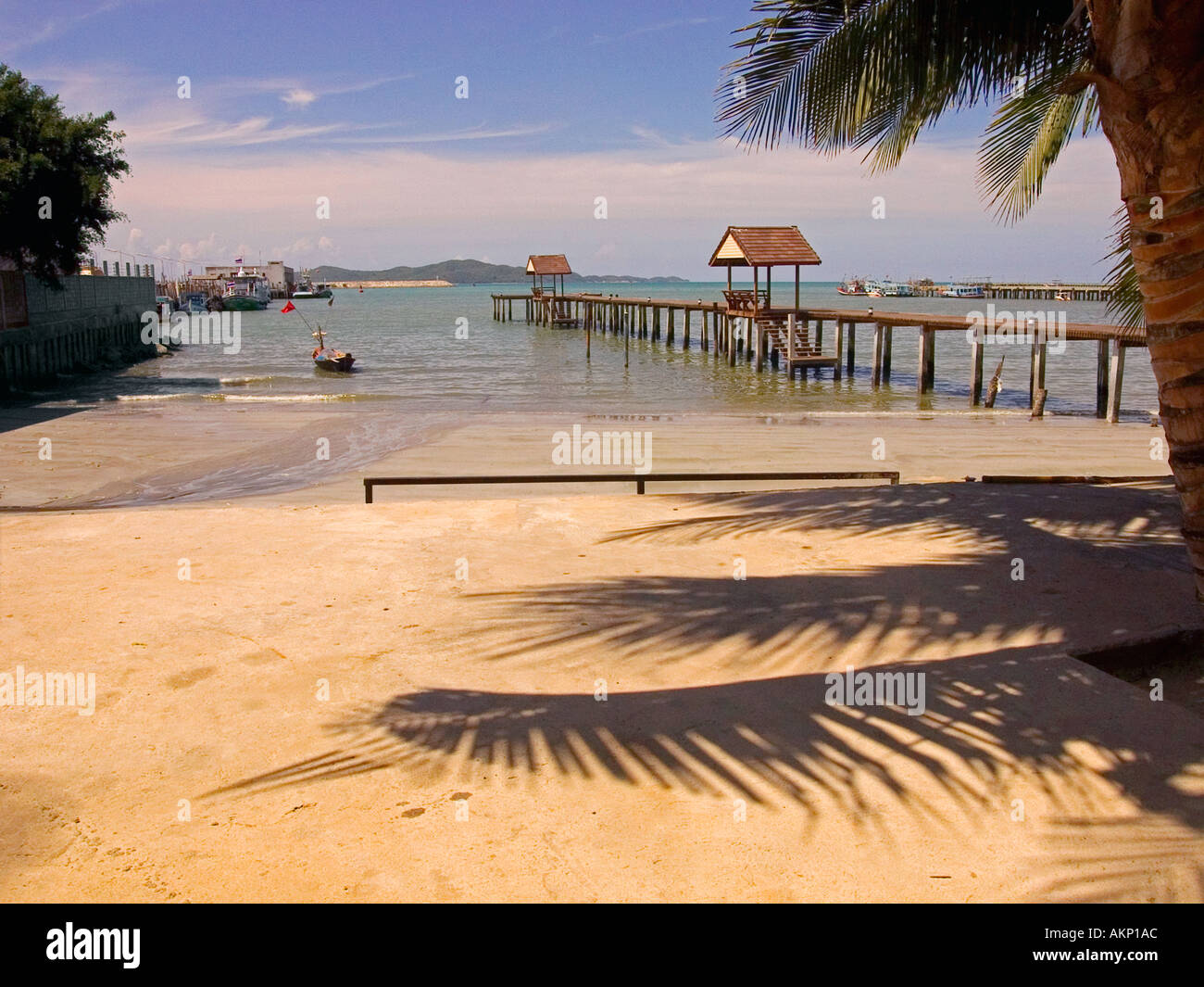 Jetty and boats at Ban Phe Rayong Thailand, palm tree and shadows on ...