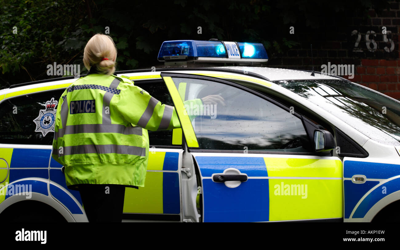 Female police officer and car Stock Photo - Alamy