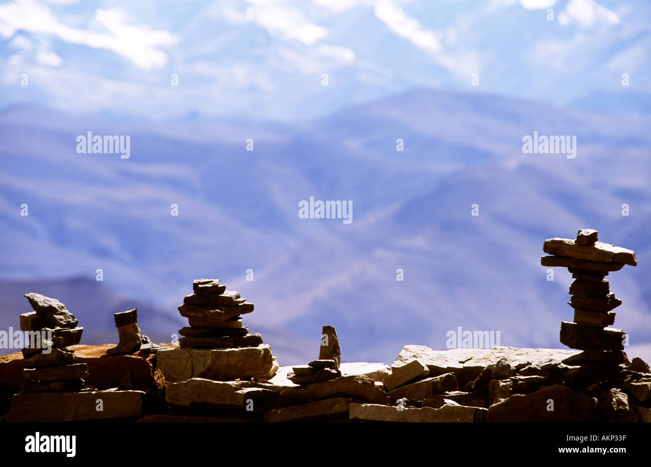 Stacked stones in to a pyramid at the edge of a Tibetan road at a high ...