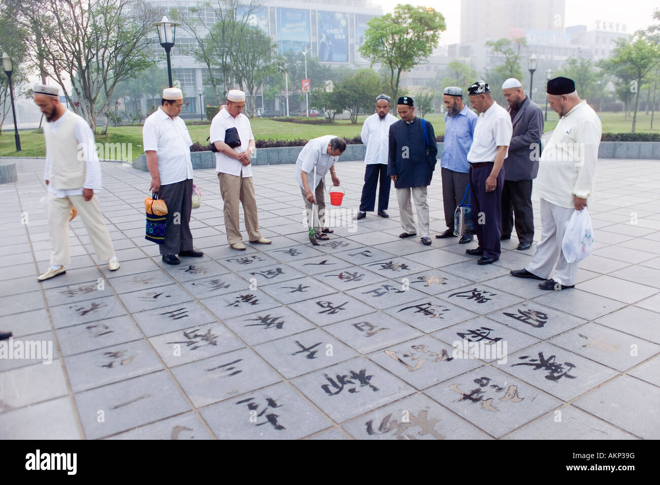 Chinese write calligraphy on the ground, some people look at it Stock ...