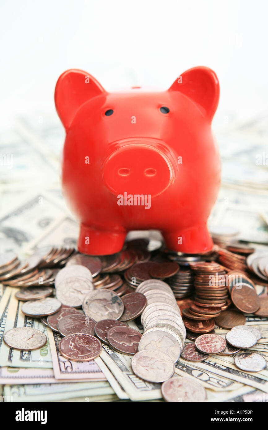 Red piggy bank on pile of money isolated on white background Stock ...
