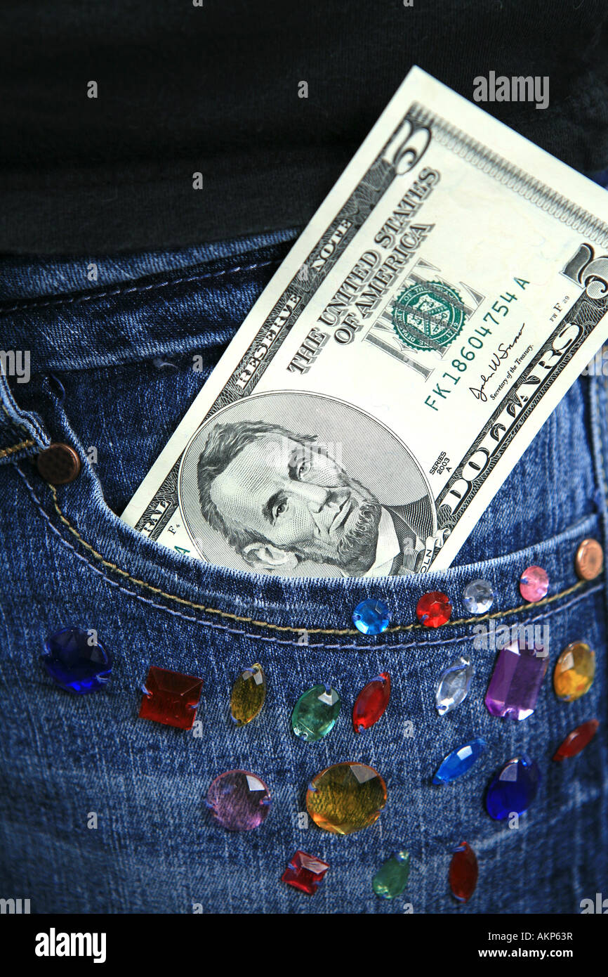 Money in girls jeweled jean pocket Stock Photo - Alamy