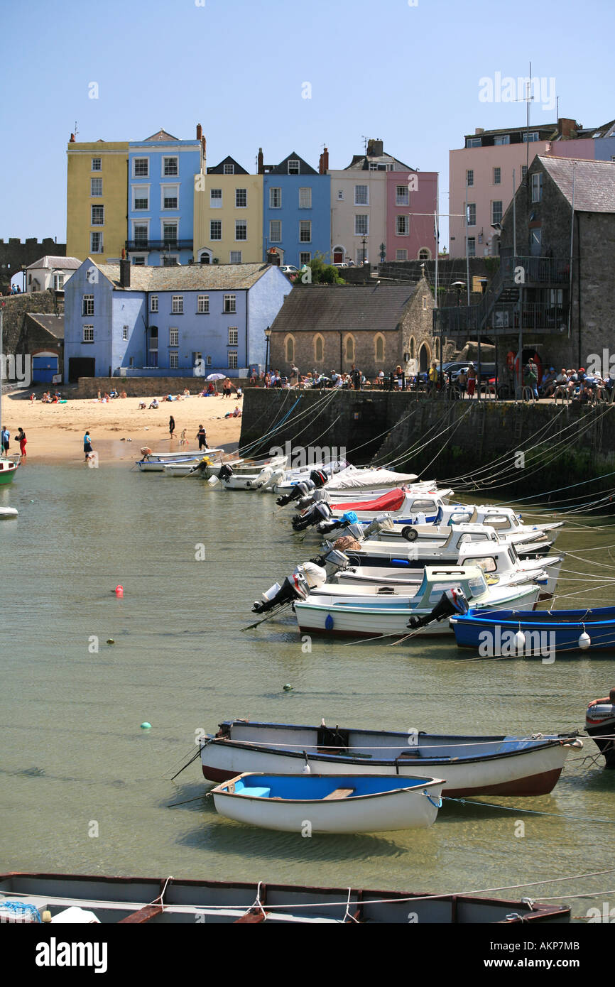 Tenby's famous pastel painted buildings stand behind the small inner ...