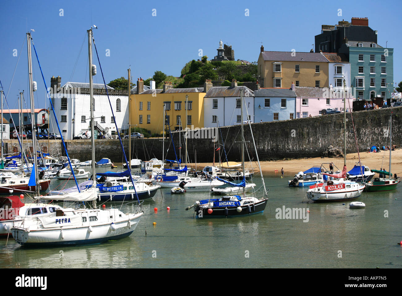 Tenby's famous pastel painted buildings stand behind the small inner ...